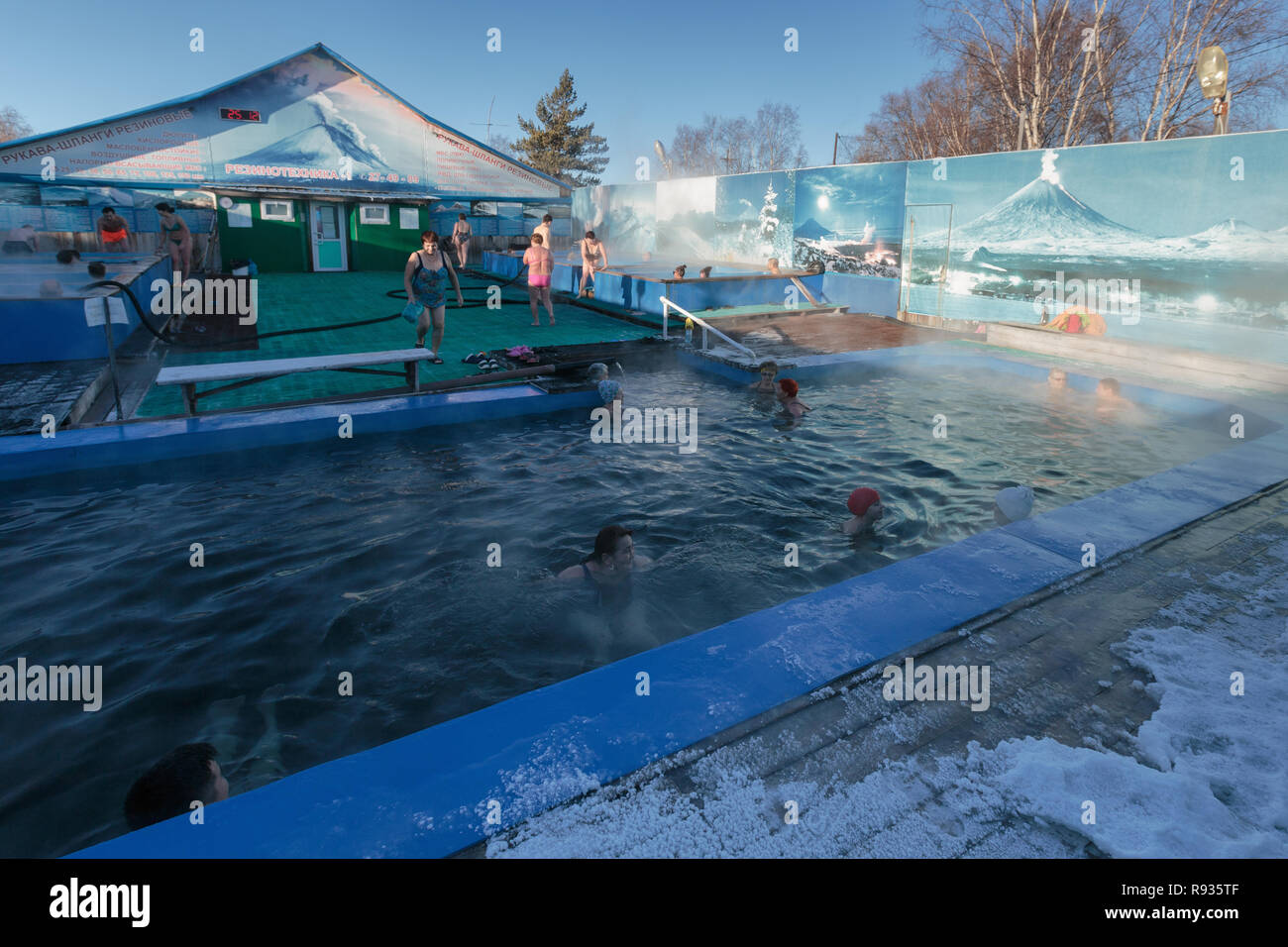 Group of people bathing in outdoors spa pool with natural thermal ...