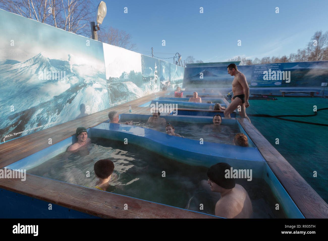Men and women enjoying bathing relaxed in spa pool with natural thermal ...