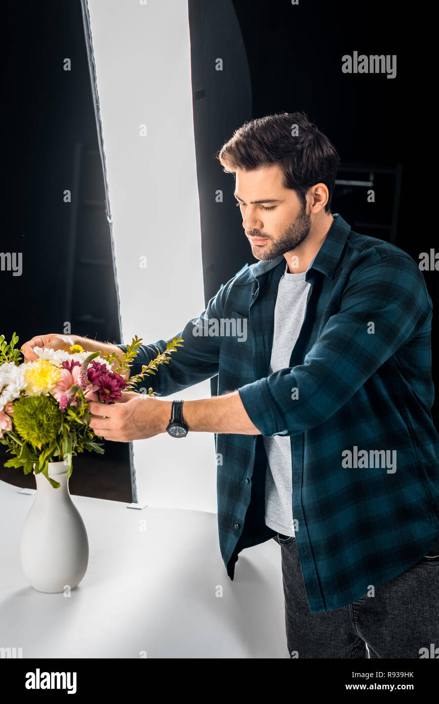 handsome young man arranging flowers in professional photo studio Stock ...