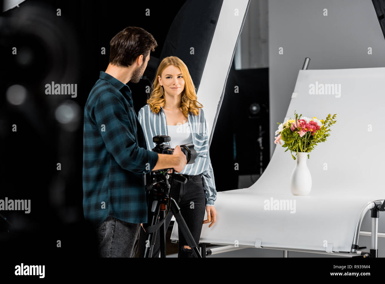 selective focus of young photographers shooting beautiful flowers in ...