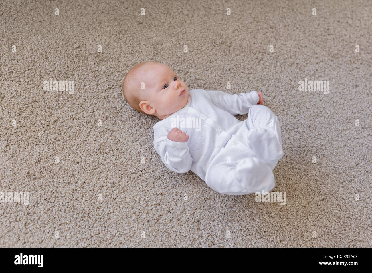 Child, childhood and infant concept - Pretty baby lie on the floor ...