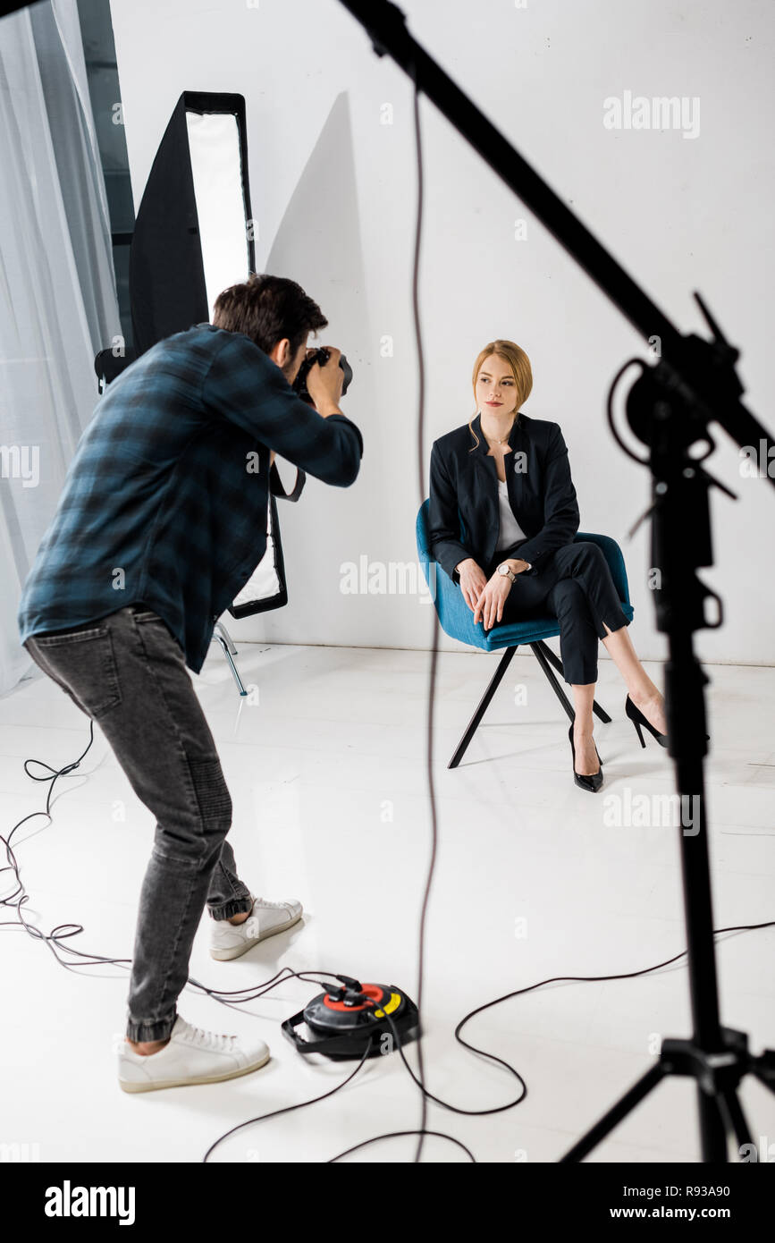 young man photographing beautiful female model in photo studio Stock ...