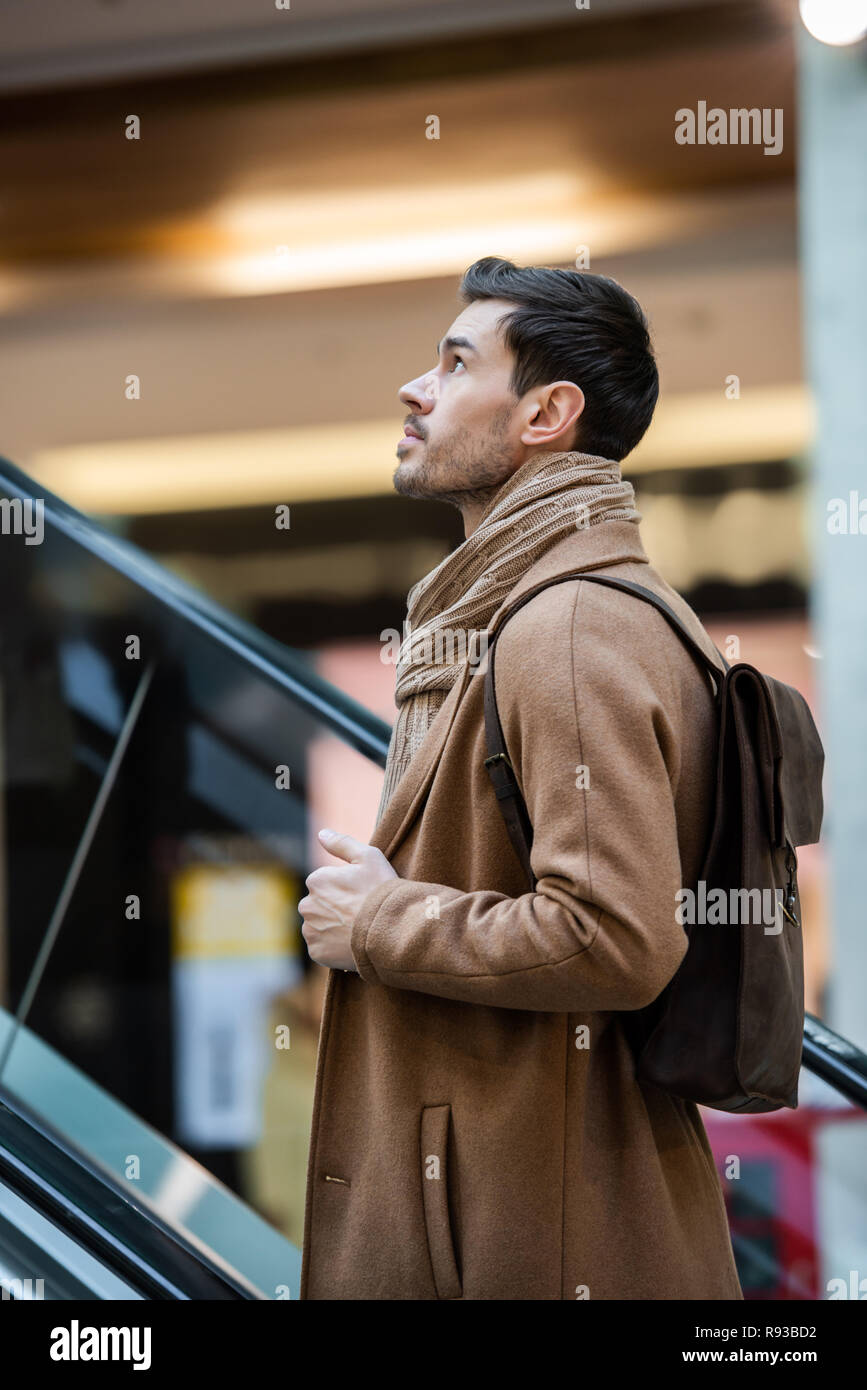 handsome man going up on escalator in shopping mall Stock Photo - Alamy