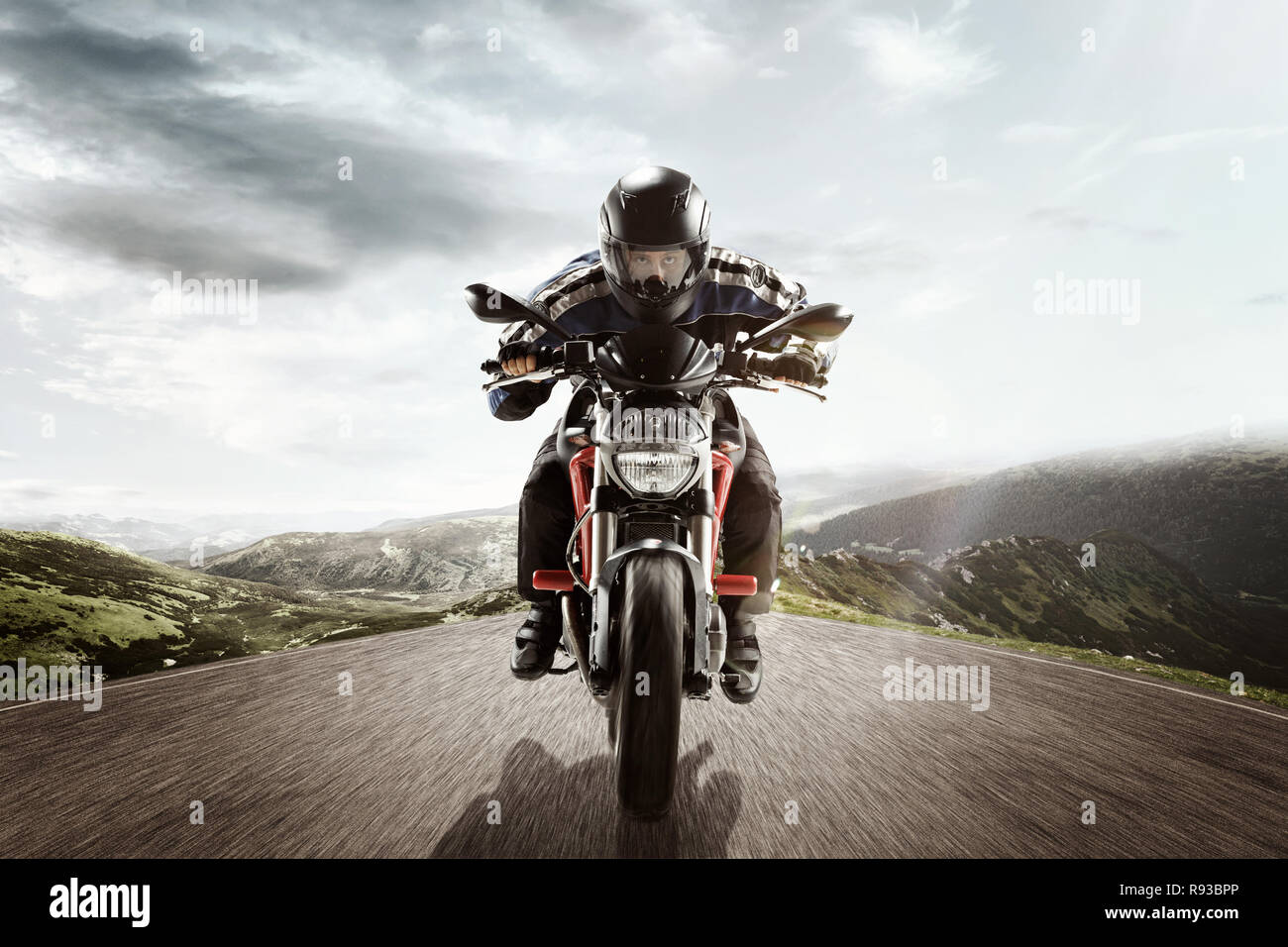 The biker in action or movement on mountain highway, riding around a ...
