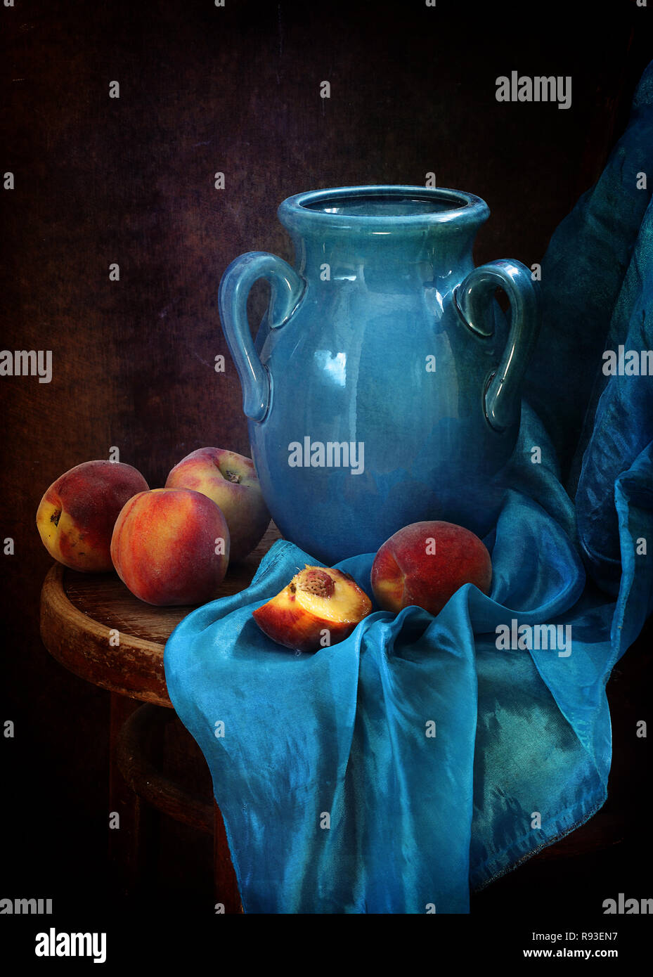 Still life with blue ceramic jug and peaches Stock Photo - Alamy