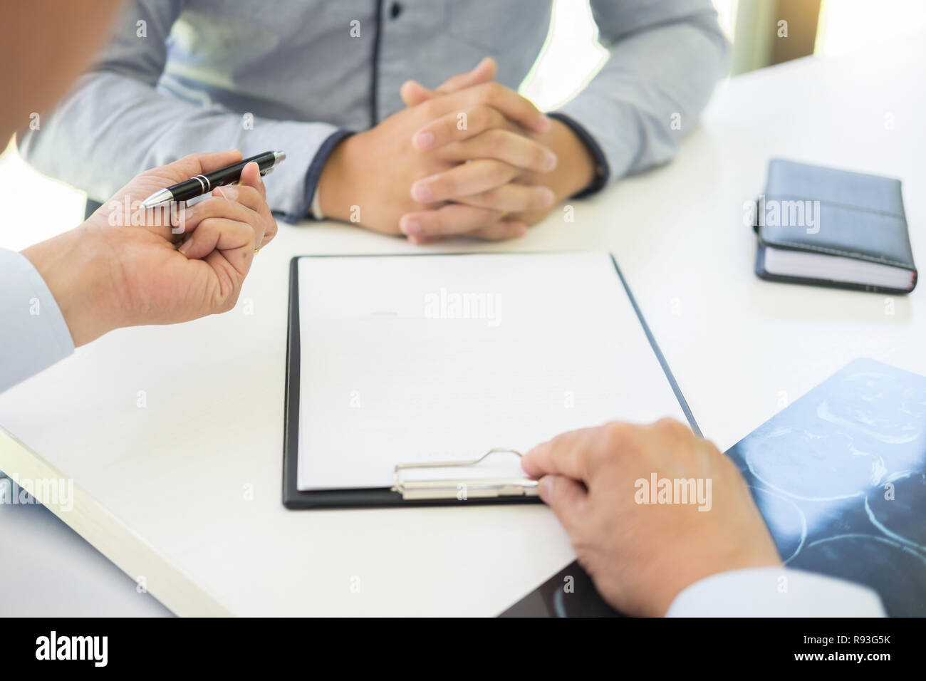 doctor giving a consultation discussing to patient and explaining ...