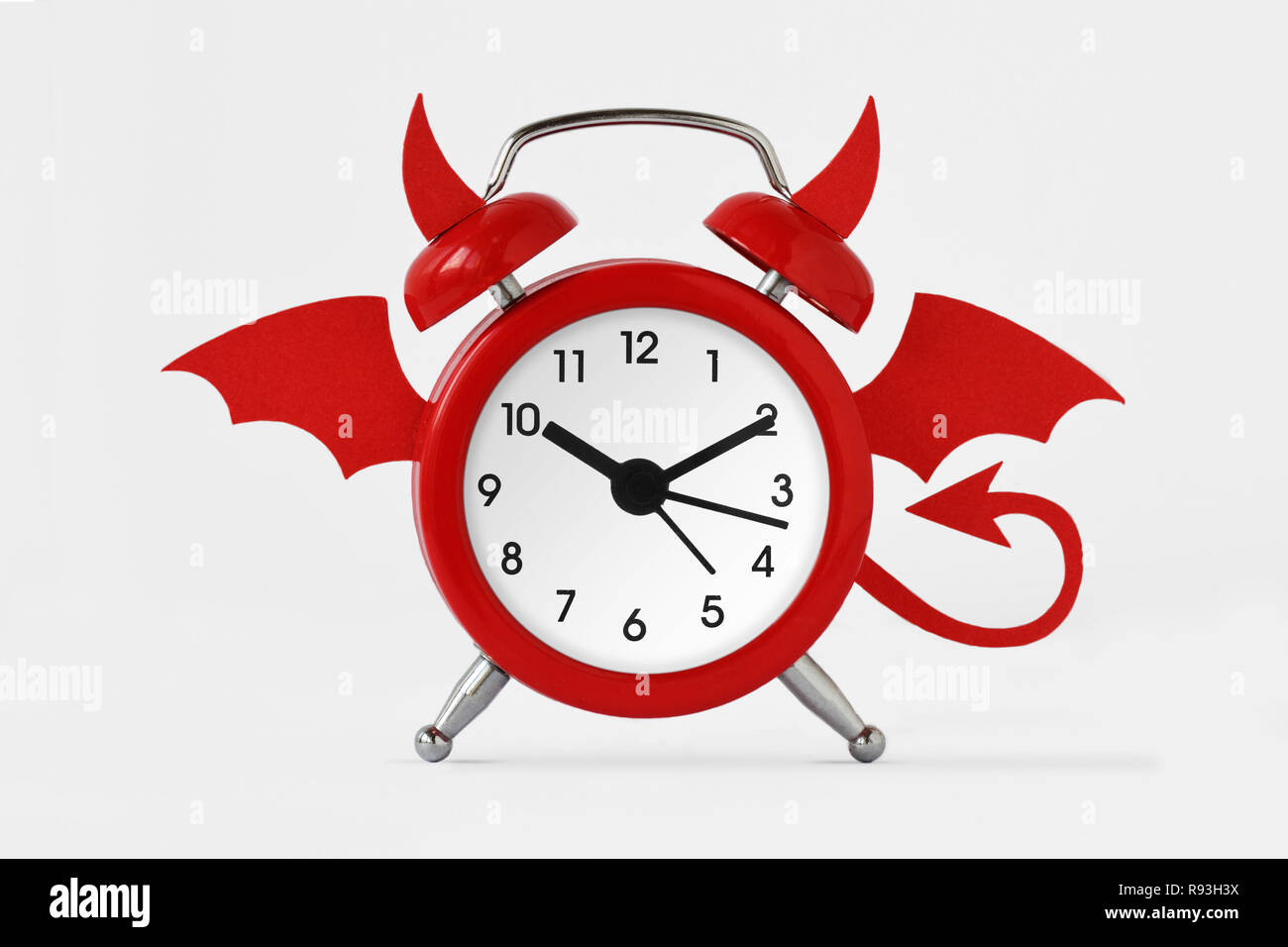 Devil alarm clock on white background Stock Photo - Alamy
