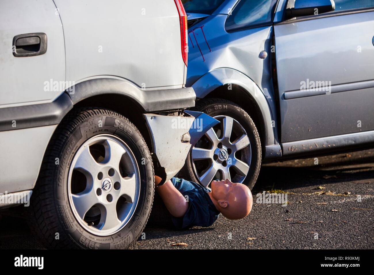 Dummy, mannequin representing a body, wedged between colliding vehicles ...