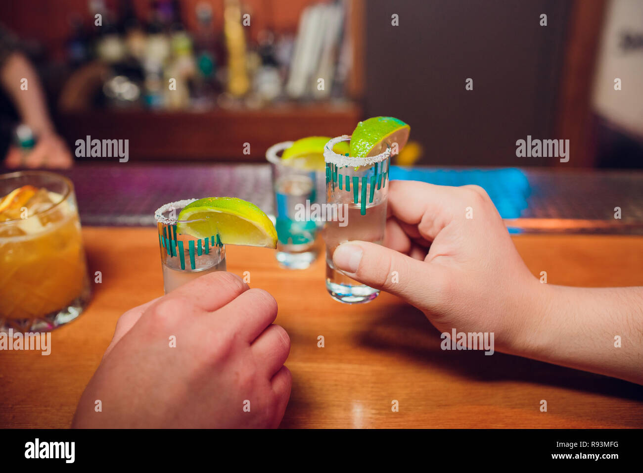 Girls hand holding straw in lime juice Stock Photo - Alamy