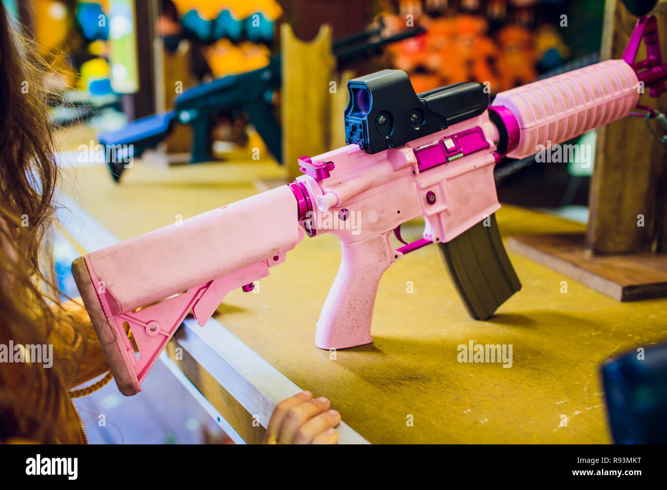 child firing hand pink gun an indoor gun range Stock Photo - Alamy