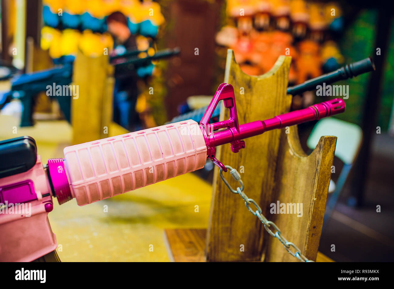 child firing hand pink gun an indoor gun range Stock Photo - Alamy