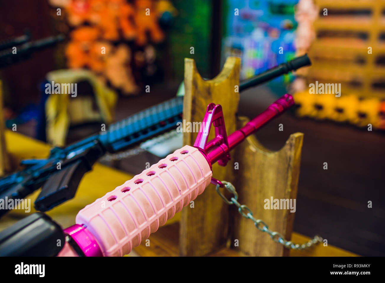 child firing hand pink gun an indoor gun range Stock Photo - Alamy