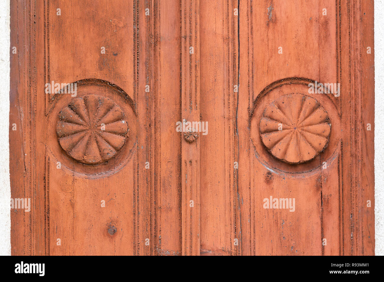 Symmetric wooden door patterns sun symbols Stock Photo - Alamy