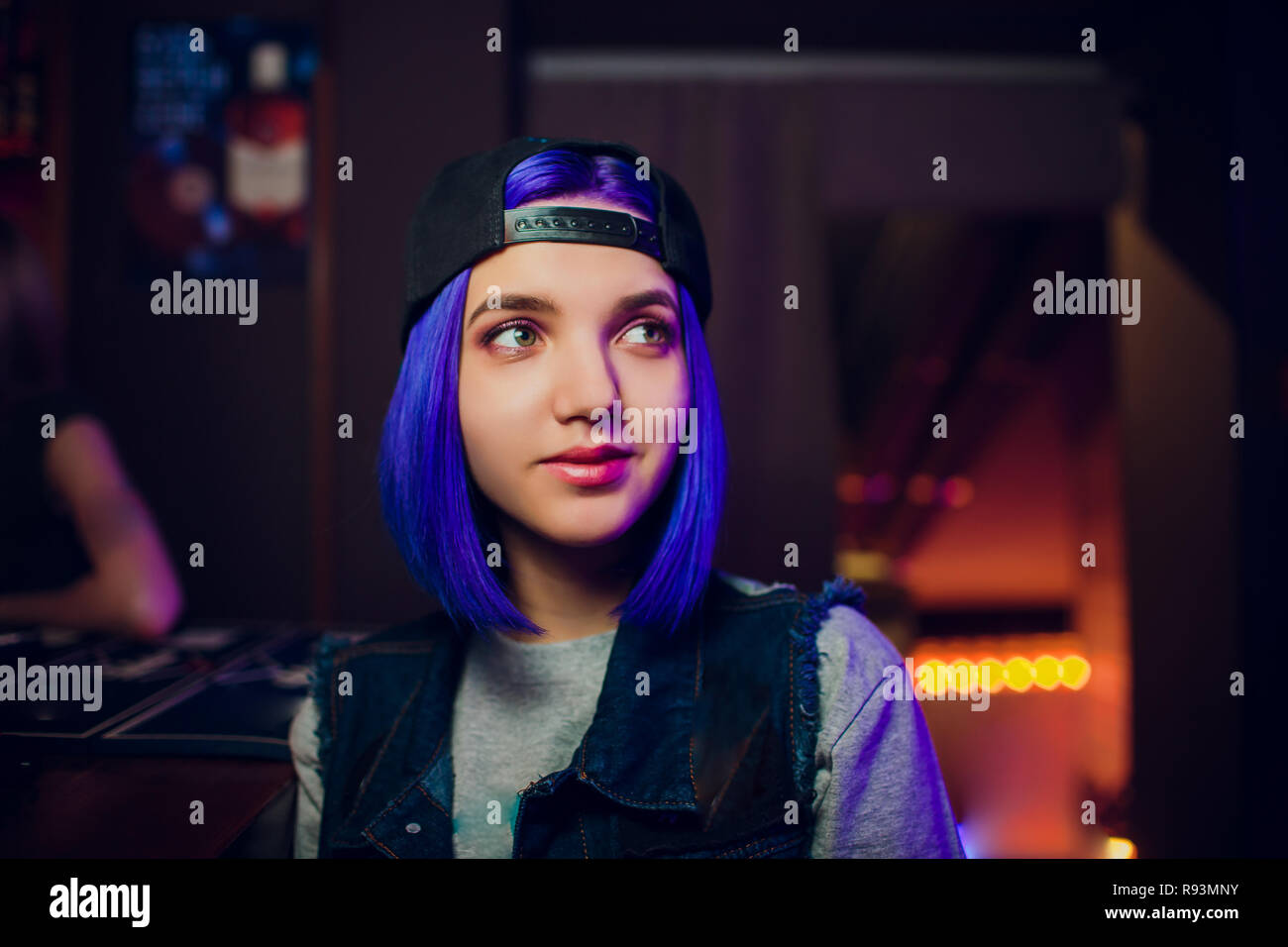 female bartender. girl with blue hair. cocktail making in night bar ...