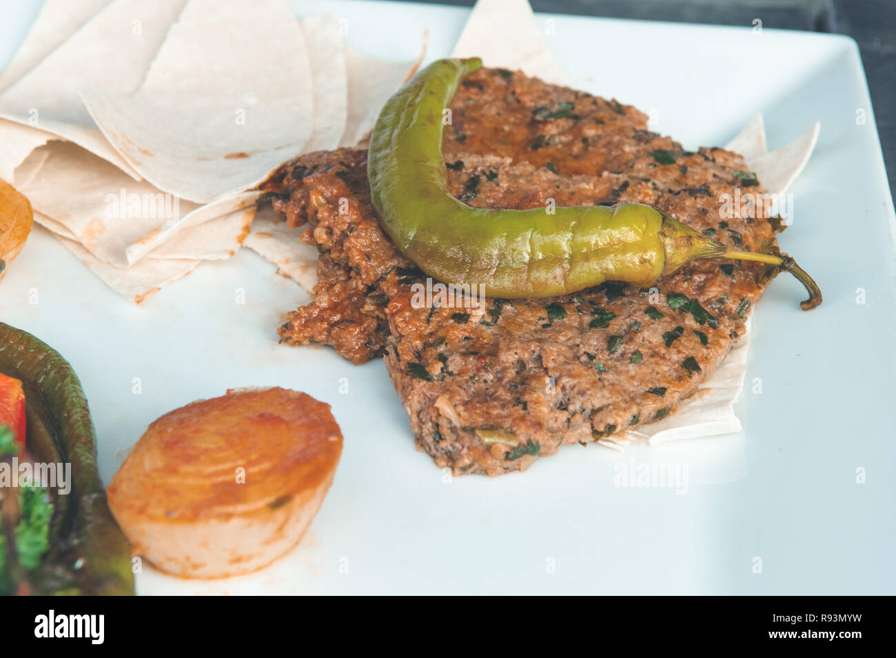 Close up of Turkish Paper Kebab (Kagit Kebap) served in a white plate ...