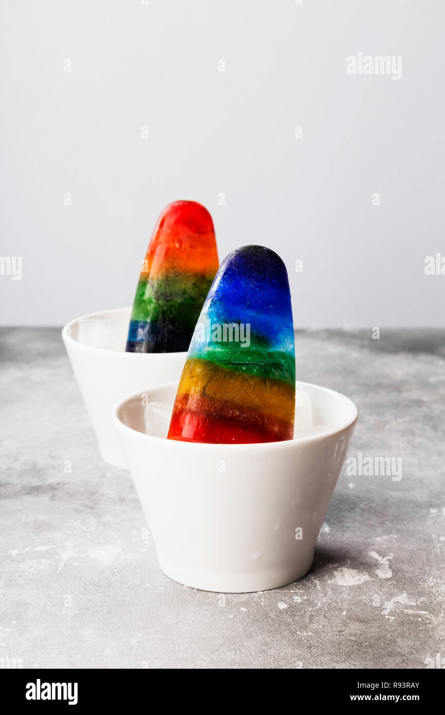Rainbow ice cream popsicle on a gray background Stock Photo - Alamy