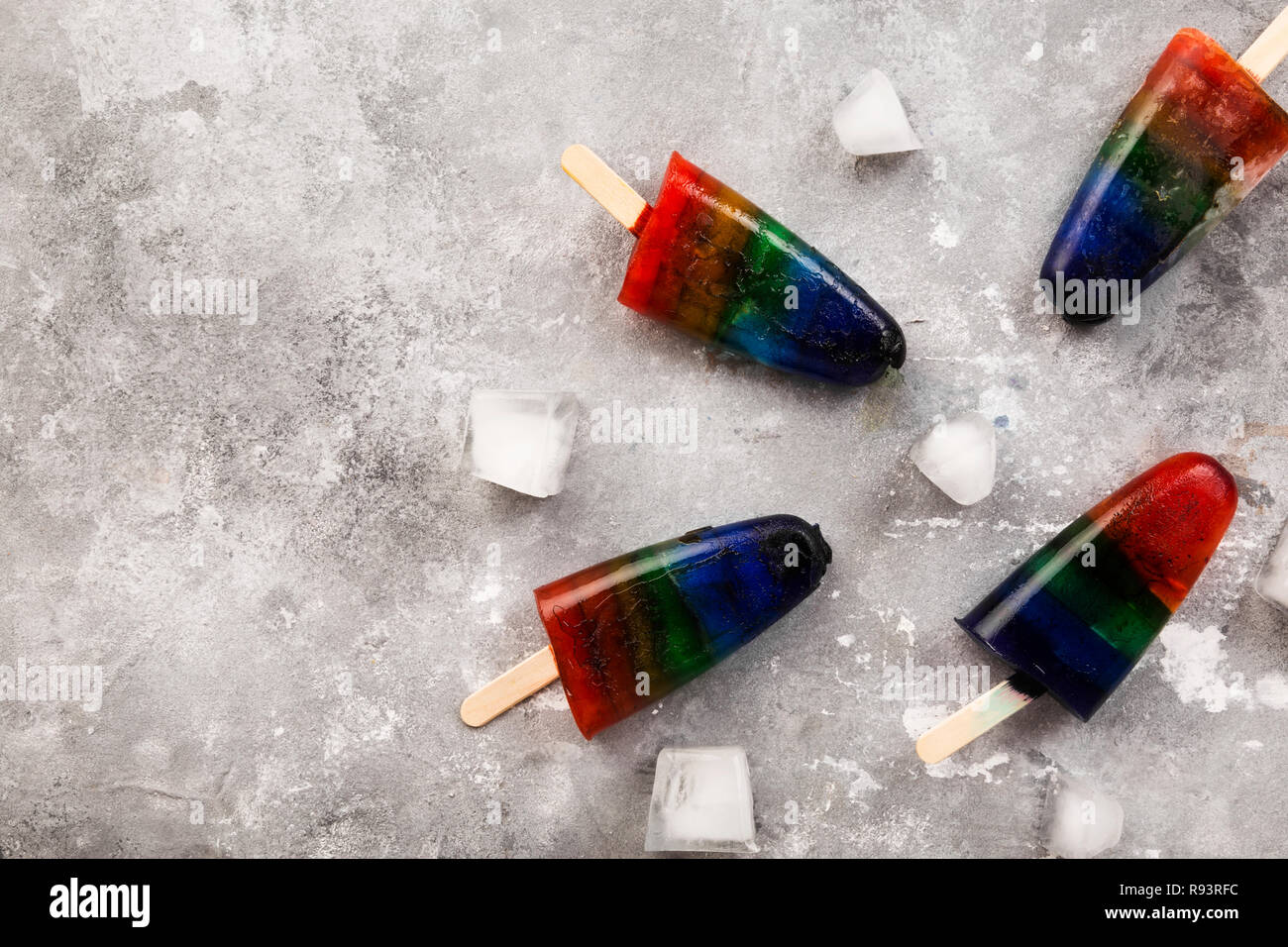 Rainbow colorful ice cream popsicle on gray background. Top view. Food ...