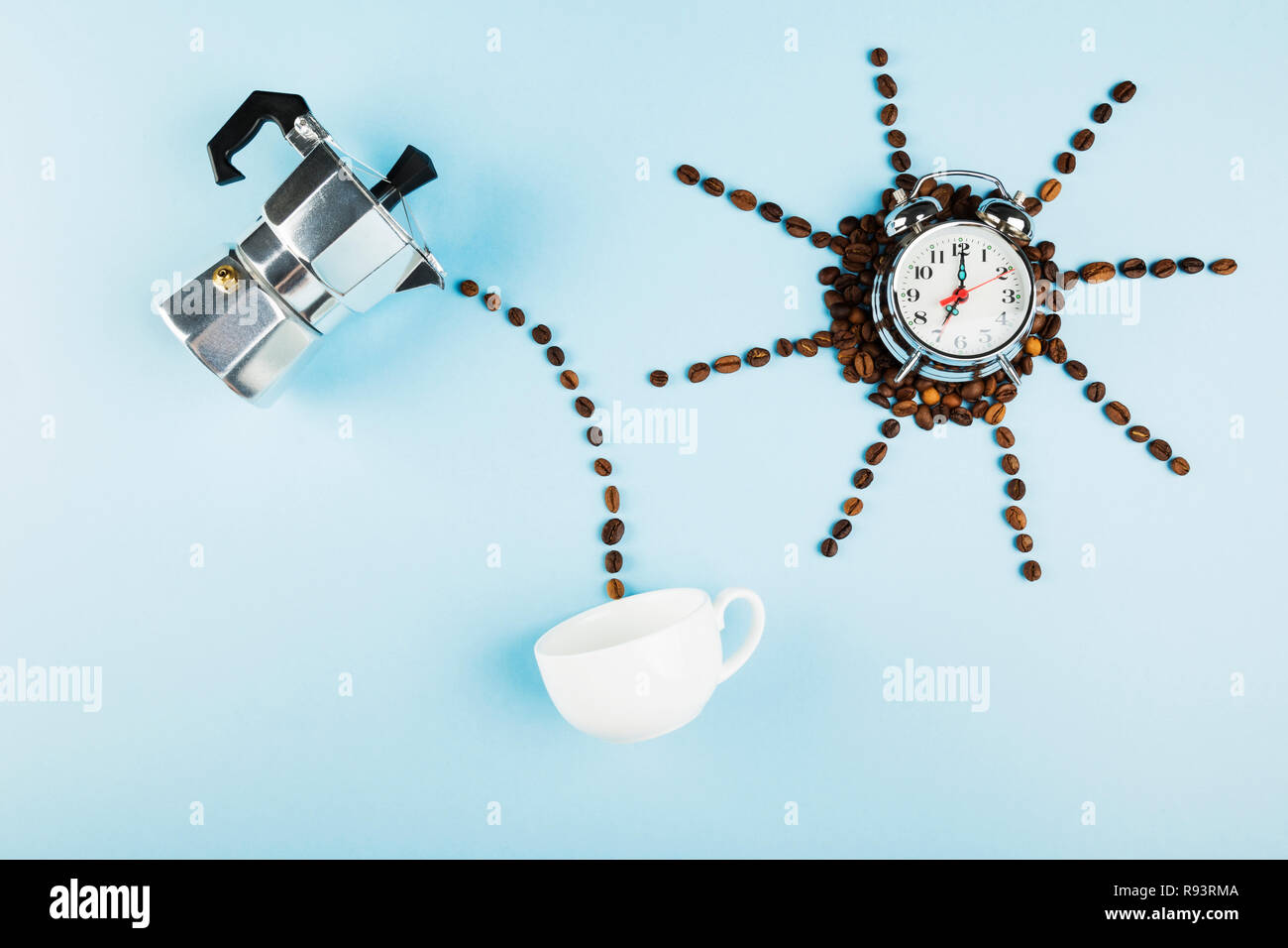 Sun made of coffee beans on blue background. Concept begins morning ...