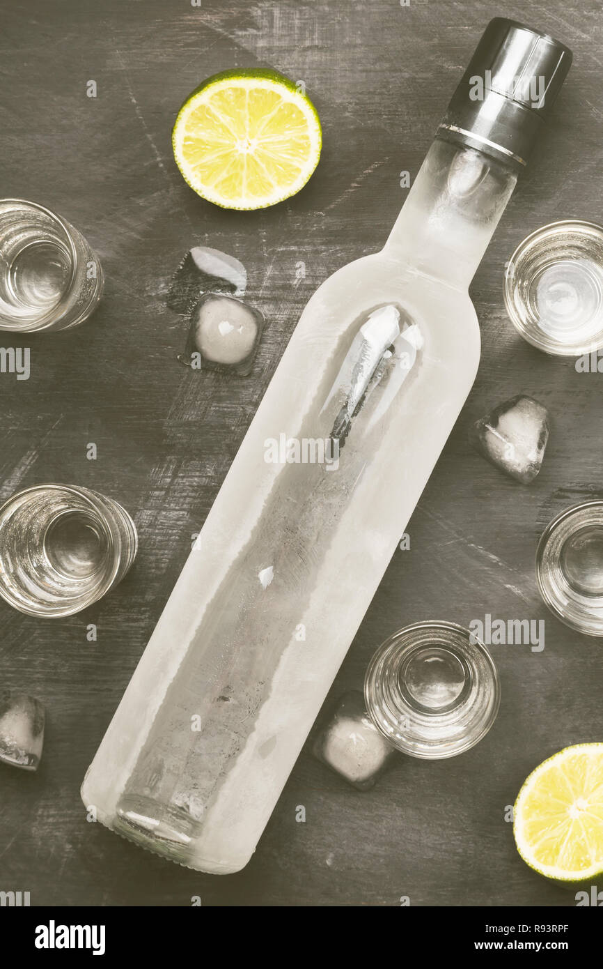 Cold vodka in shot glasses on a black background. Top view. Food ...