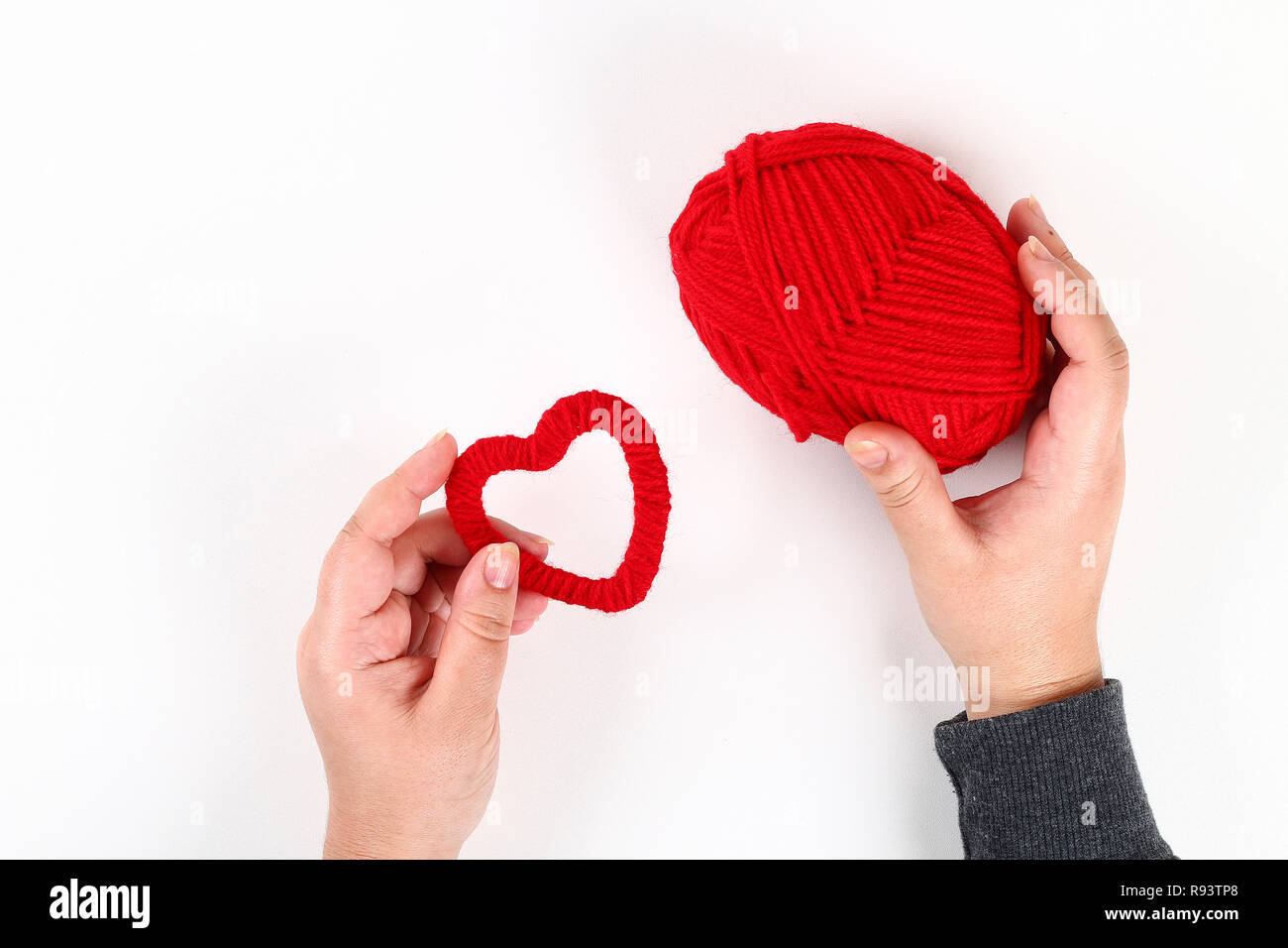 Red handmade diy hearts made of cardboard, yarn on a white background ...