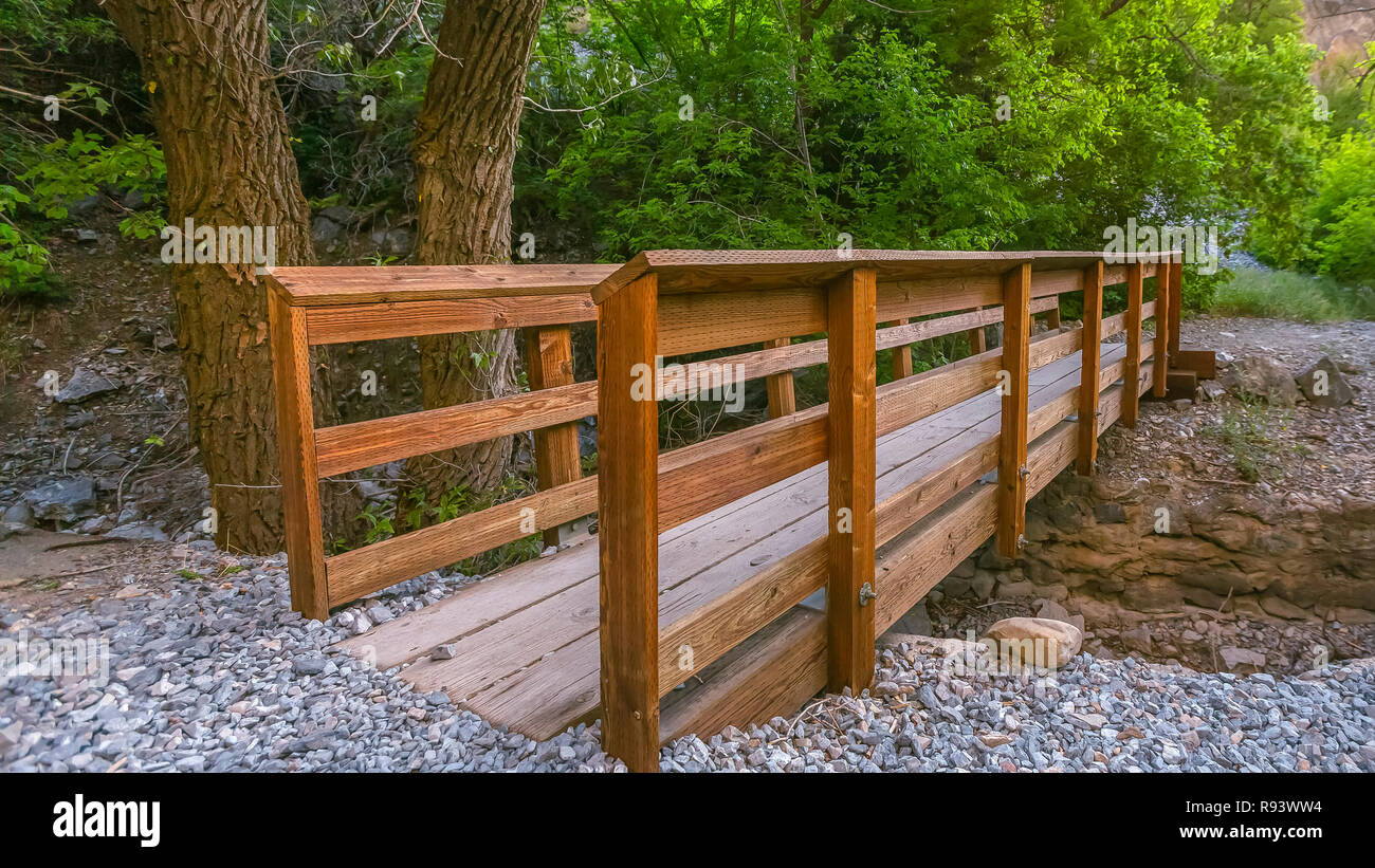 Hiking trail with wood bridge over a rocky stream Stock Photo - Alamy