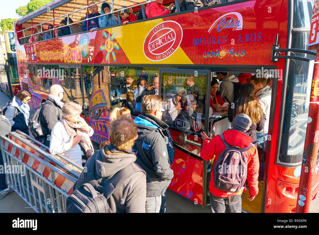ROME, ITALY - CIRCA NOVEMBER, 2017: People boarding a bus at a bus stop ...
