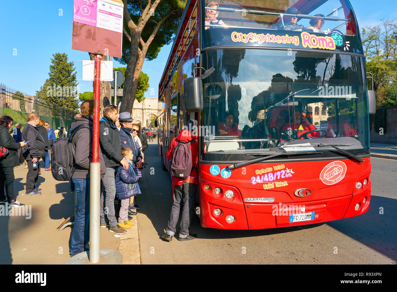 ROME, ITALY - CIRCA NOVEMBER, 2017: People boarding a bus at a bus stop ...