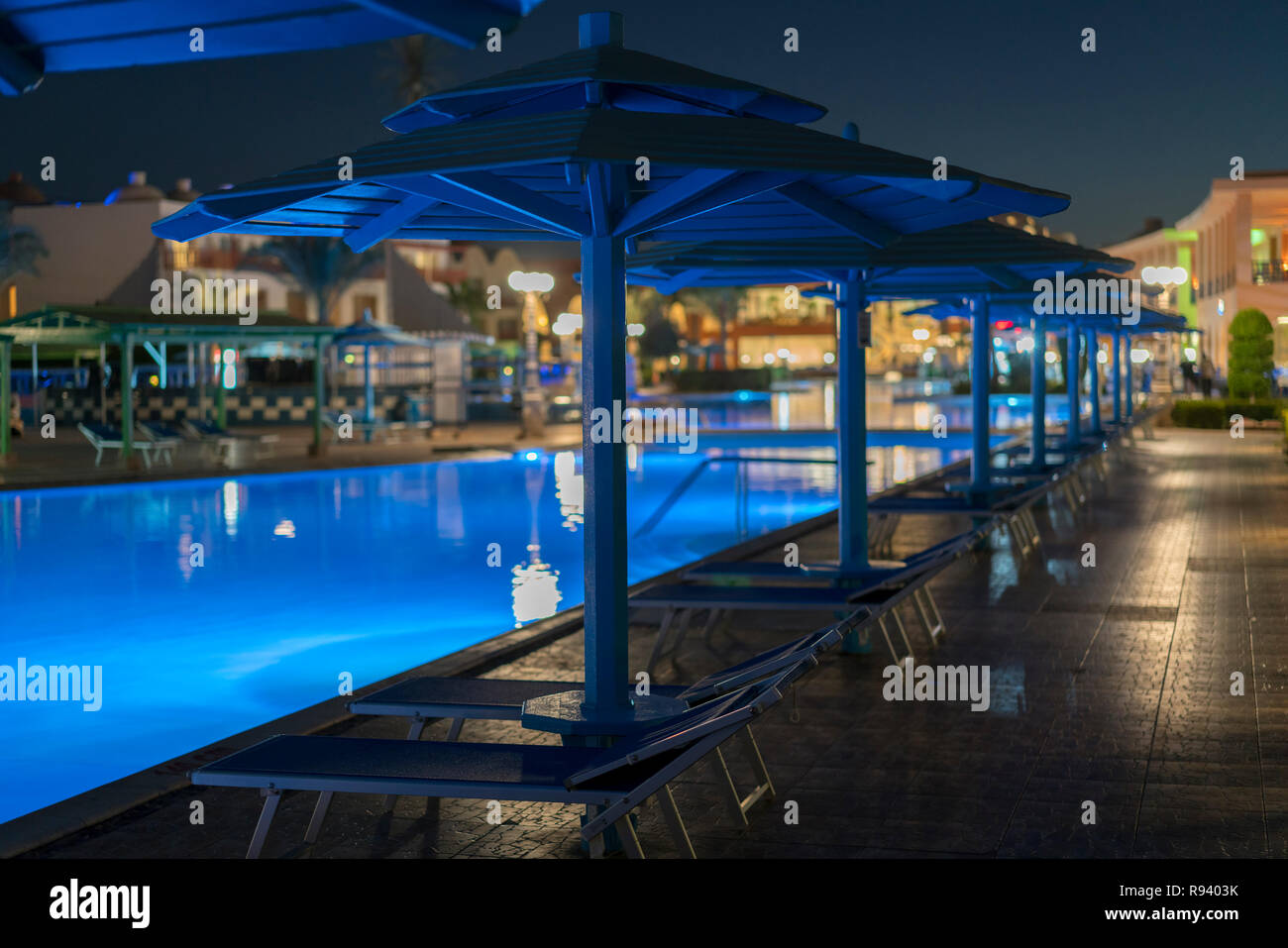 luxury resort with pool at night view. hotel outdoor landscape with ...