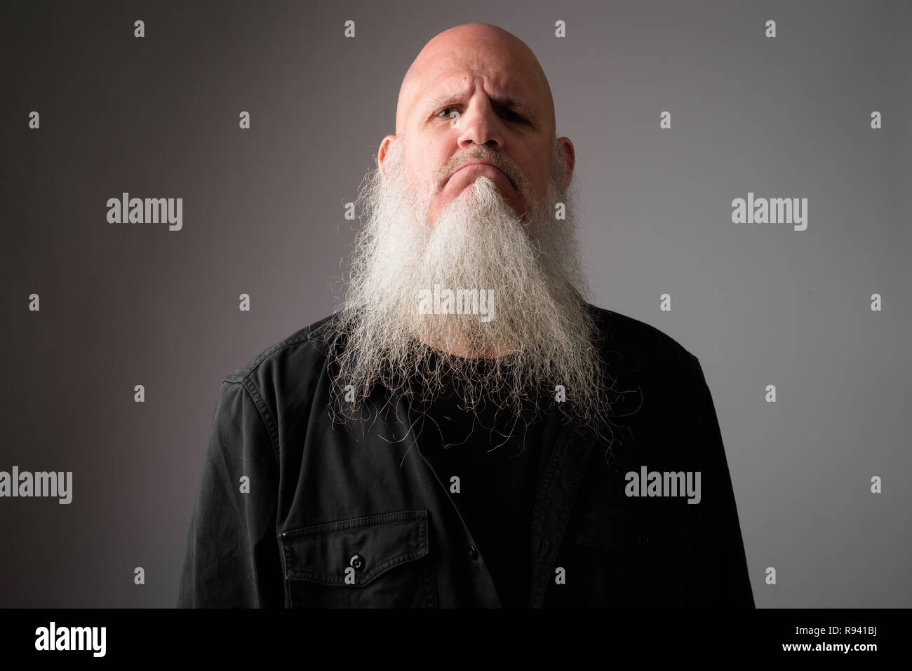 Face of mature bald bearded man looking angry Stock Photo - Alamy