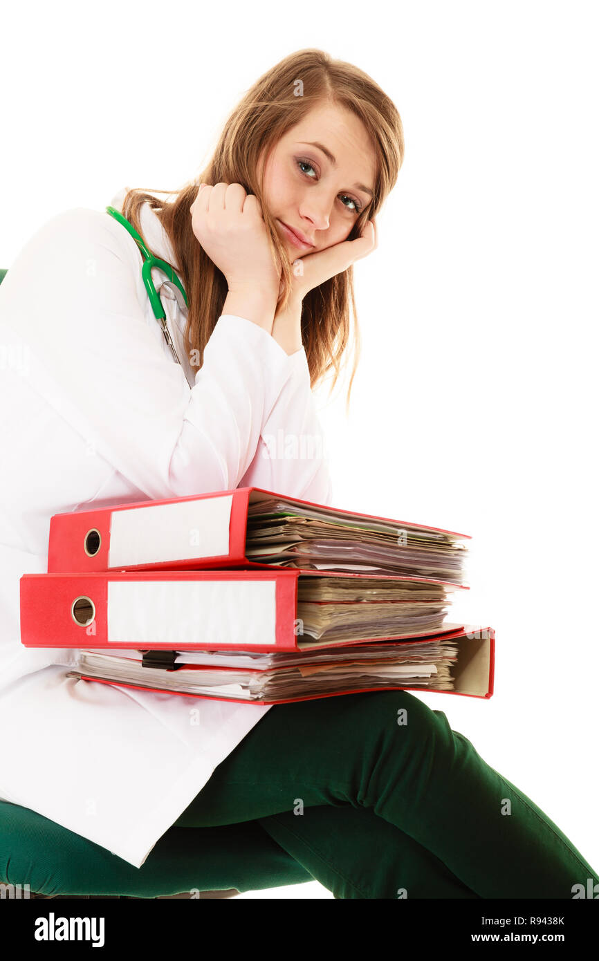 Medicine and paperwork. Tired overworked busy doctor woman with stack ...