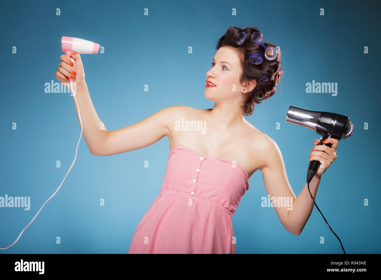 Young woman preparing to party having fun, funny girl styling hair with ...