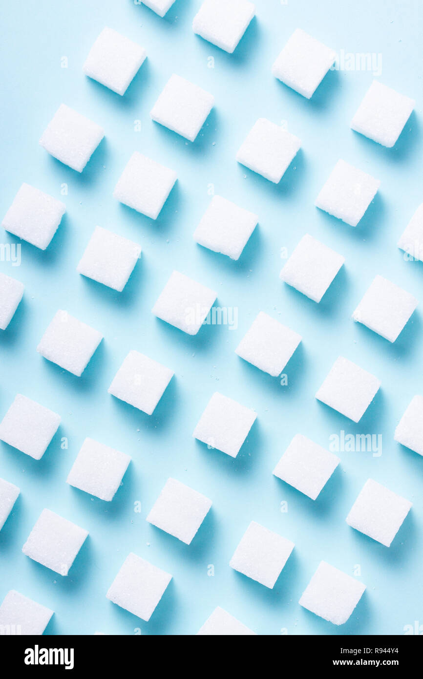Sugar on blue background Stock Photo - Alamy