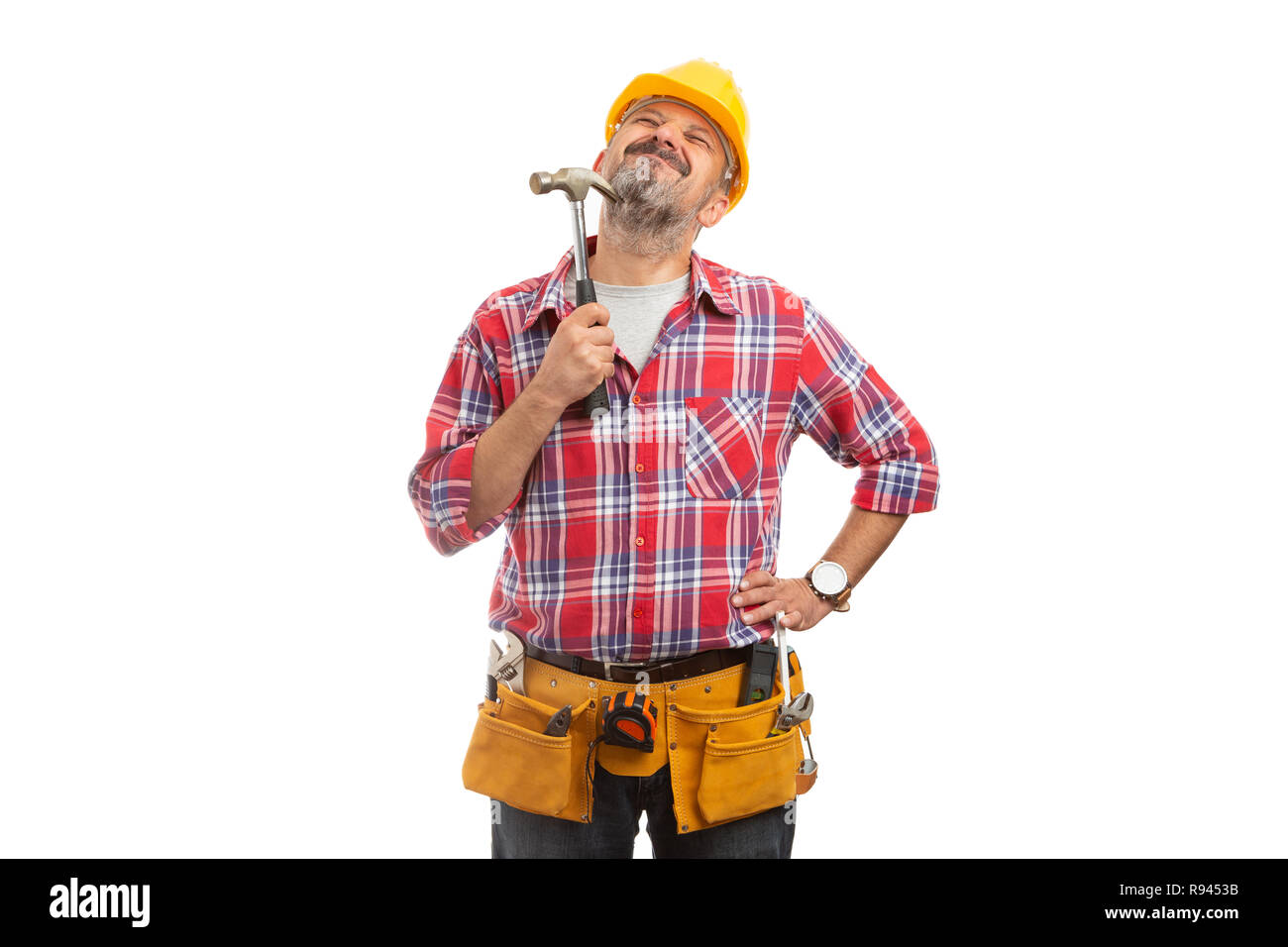 Builder having pleased expression scratching chin with facial hair by ...