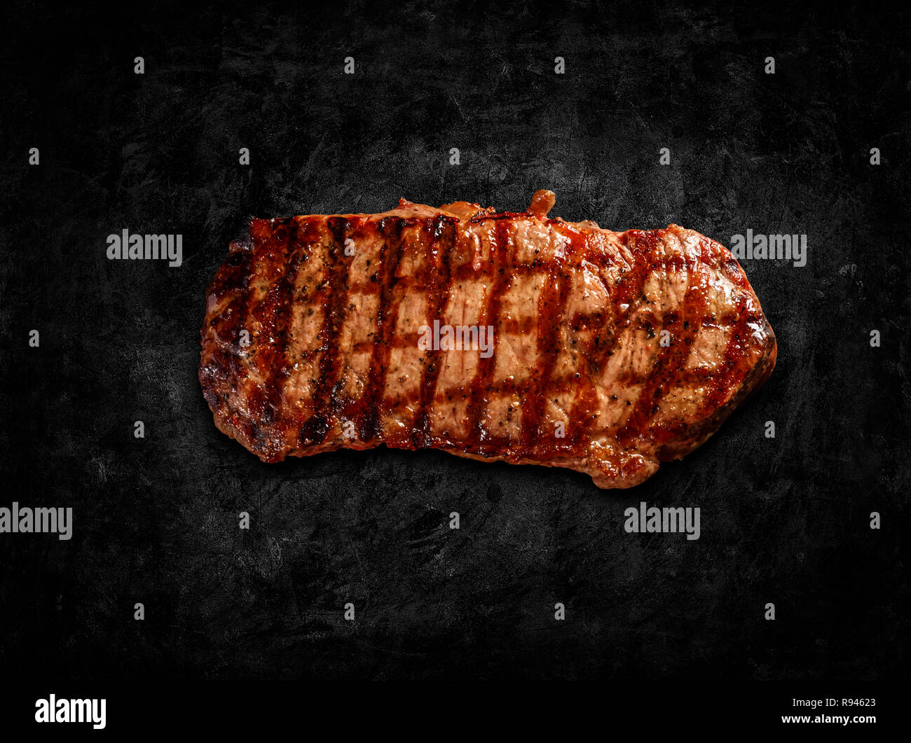 Matured Argentinian sirloin steak on black background Stock Photo - Alamy
