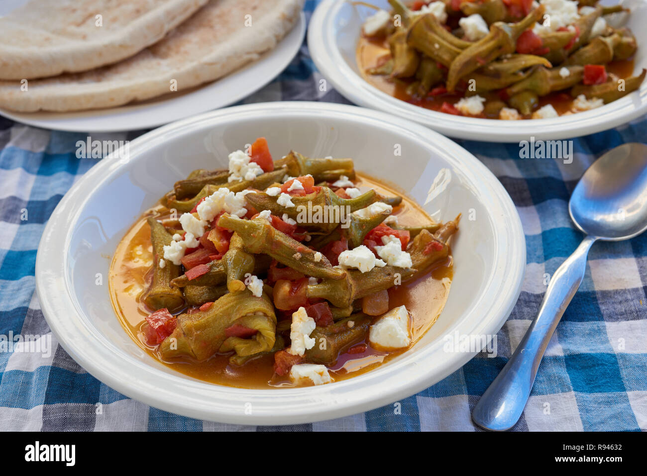 Braised okra with tomato and cheese Stock Photo - Alamy