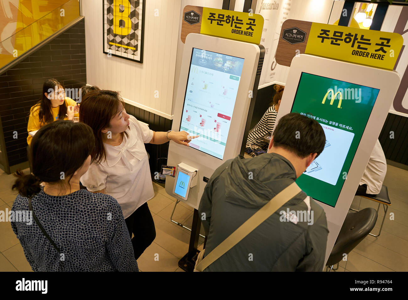 BUSAN, SOUTH KOREA - CIRCA MAY, 2017: people use ordering kiosk at ...