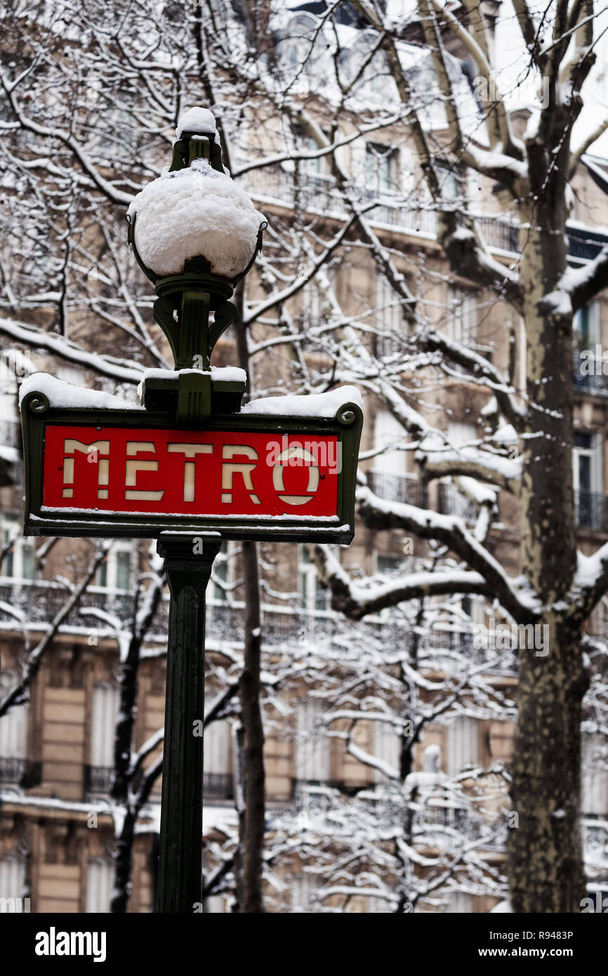 Famous Parisian metro sign and trees after snowfall in winter, France ...