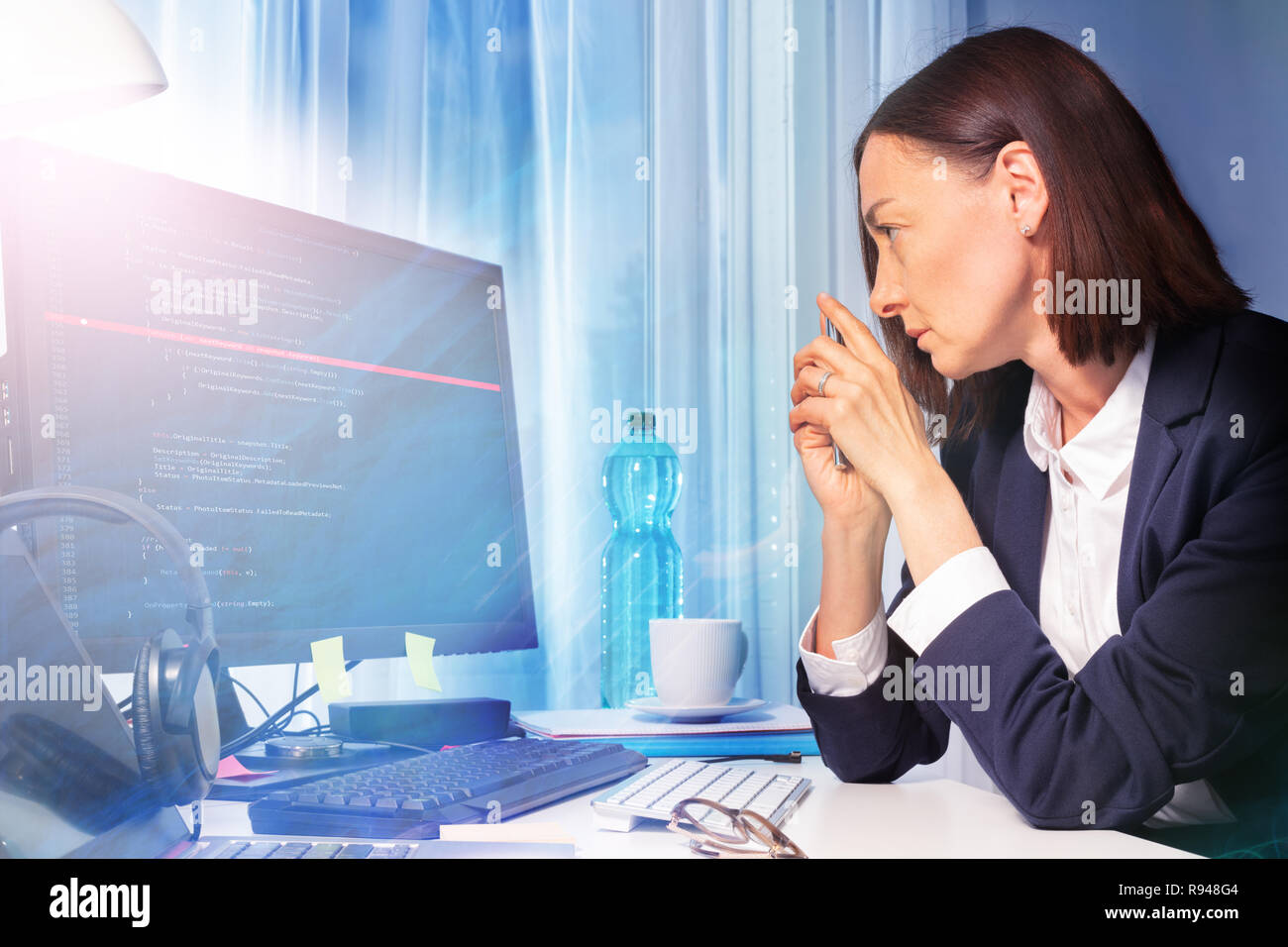 Side view portrait of businesswoman looking at the screen of computer ...