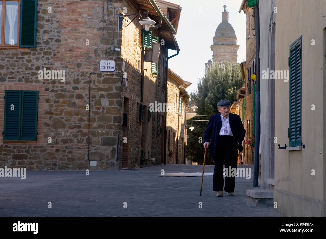 Old man walking up Via Spagni, Montalcino, Tuscany, Italy Stock Photo ...