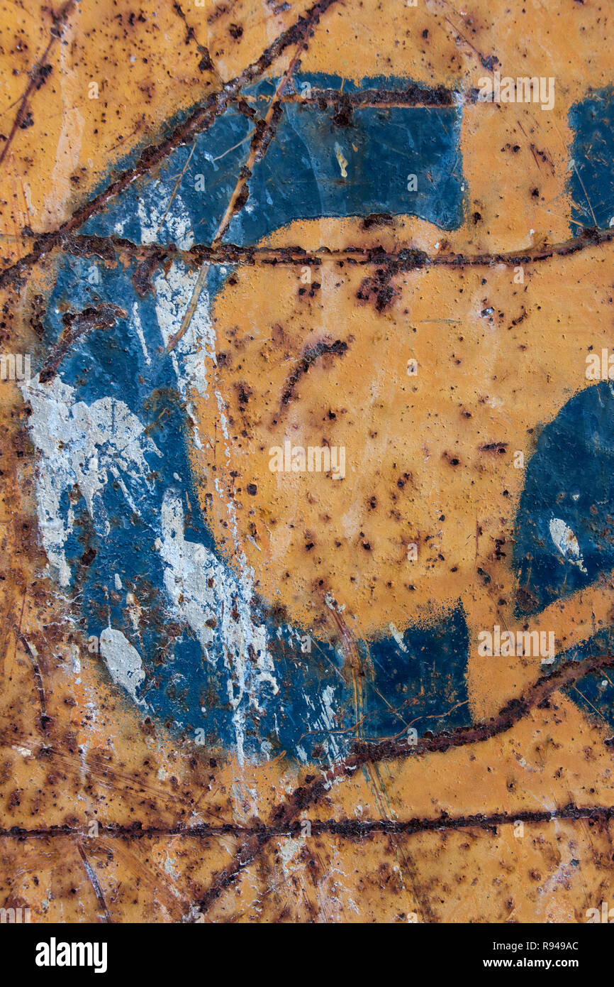 blue letter on rusty metal, blue stencil painted on rusty background ...