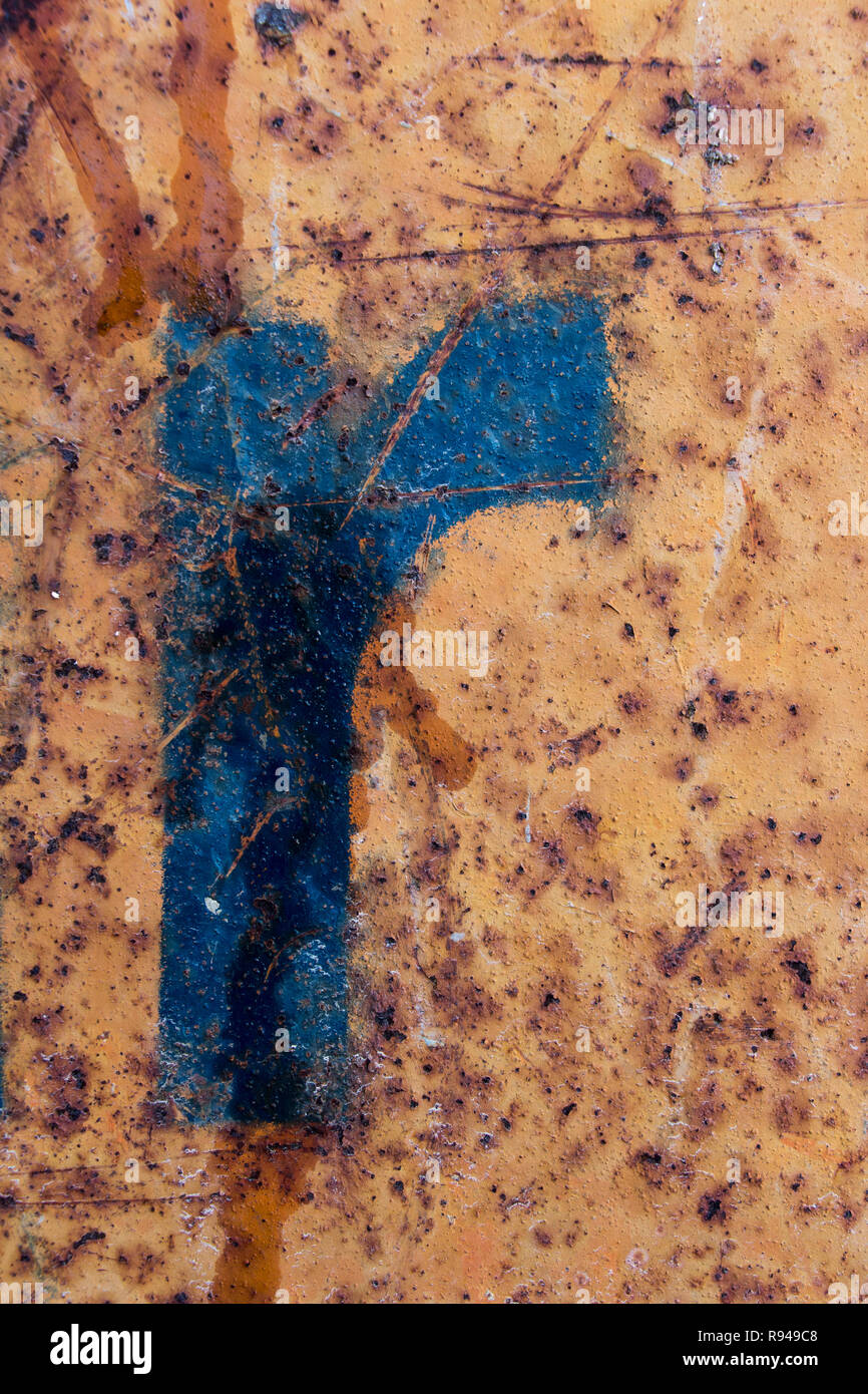 blue letter painted on rusty blue metal, blue stencil painted on rusty ...