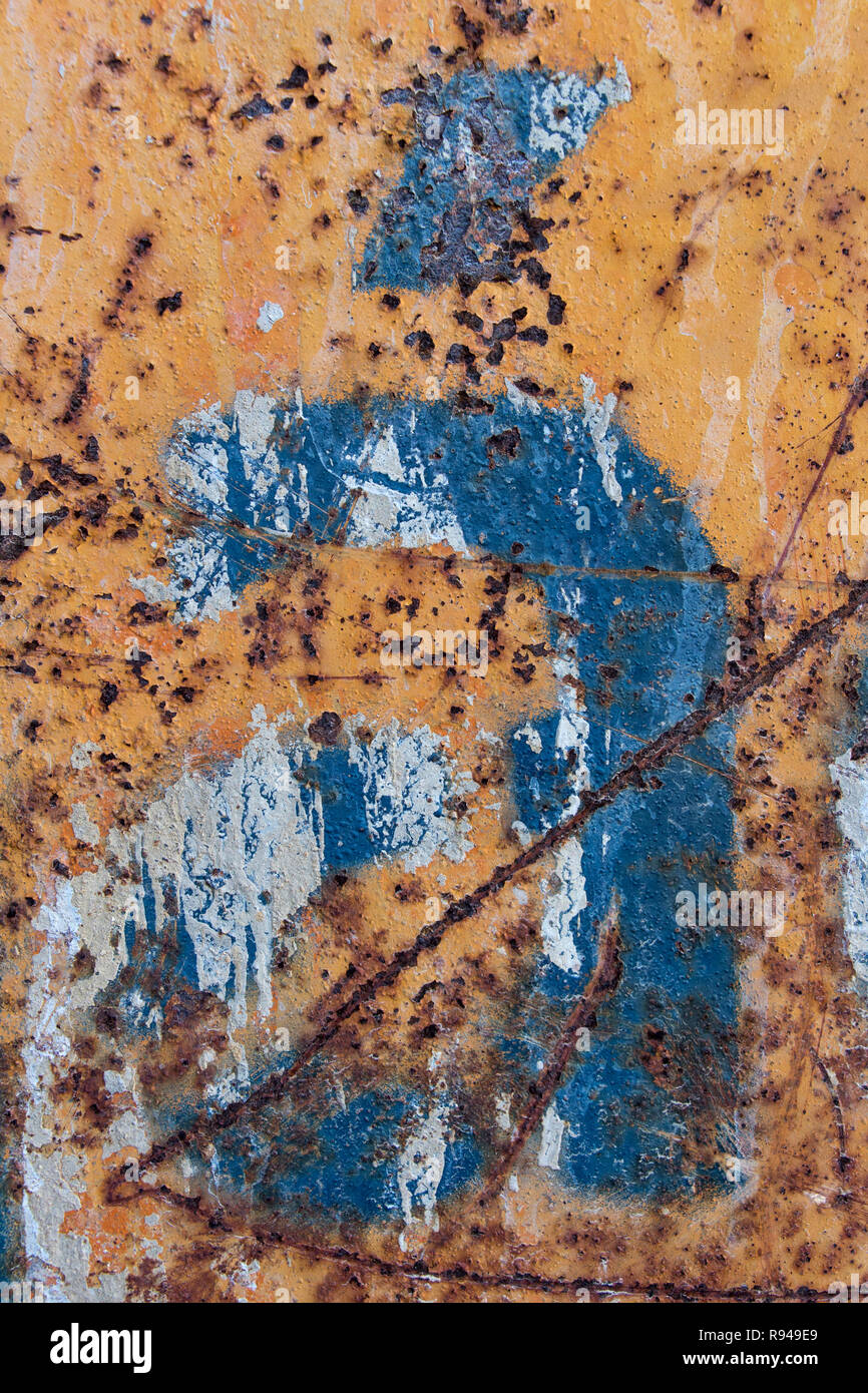 blue letter with tilde scratched rusty metal background, blue stencil ...