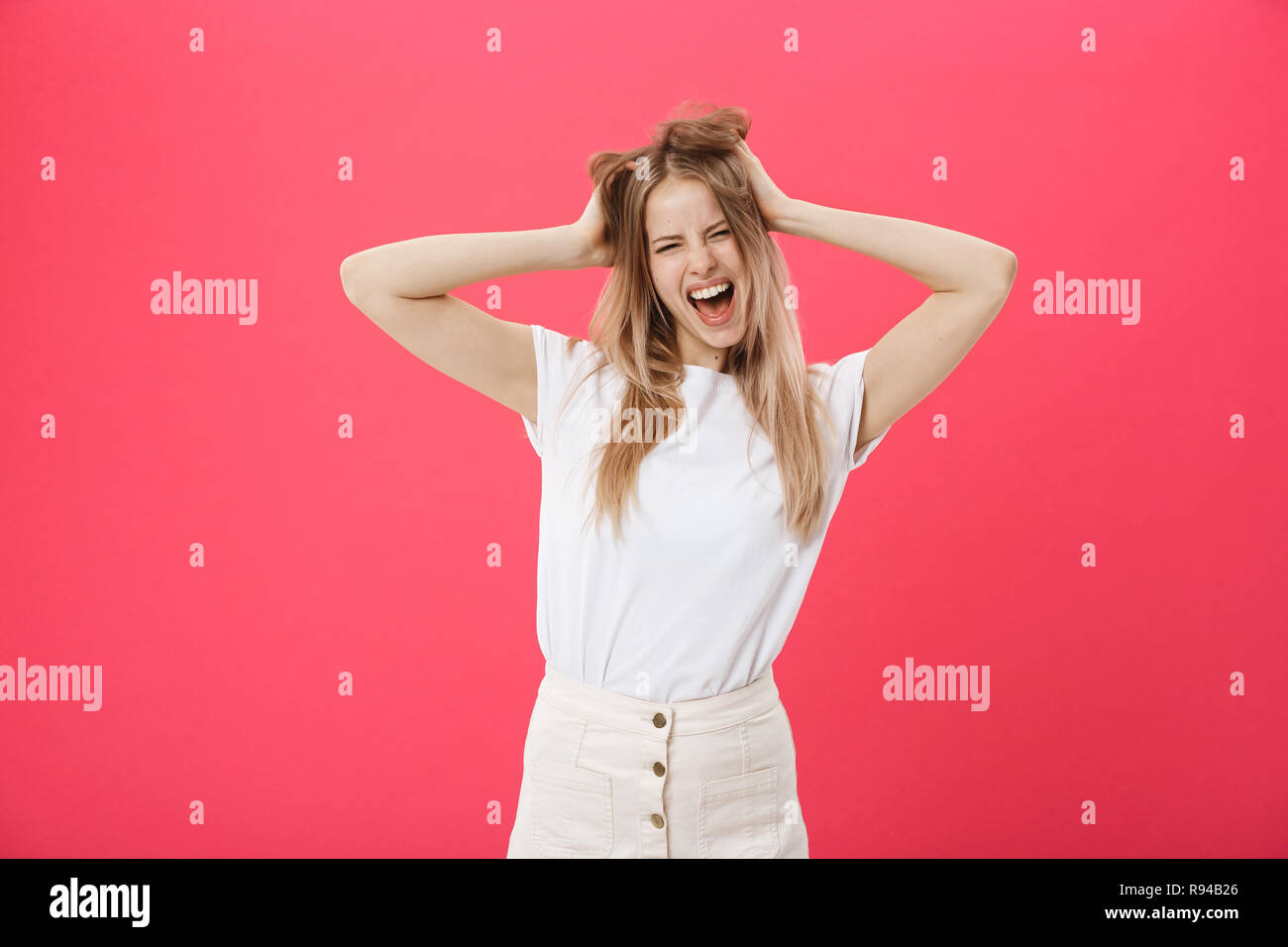 Young woman getting angry ,crazy and shouting isolated on a pink ...