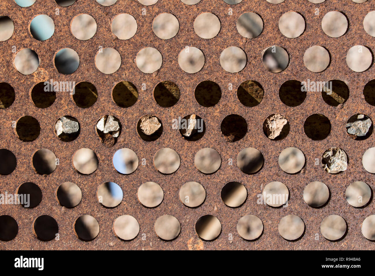 detail of perforated and rusty metal, rusty and leaky metal plate ...