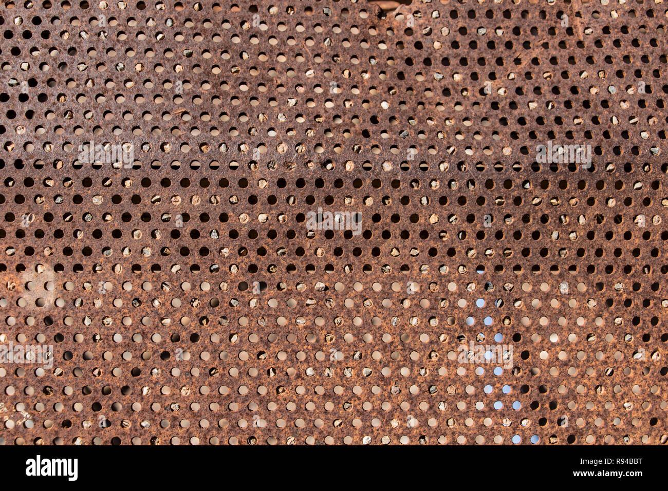 perforated and rusty metal, rusty and leaky metal plate, metal corroded ...