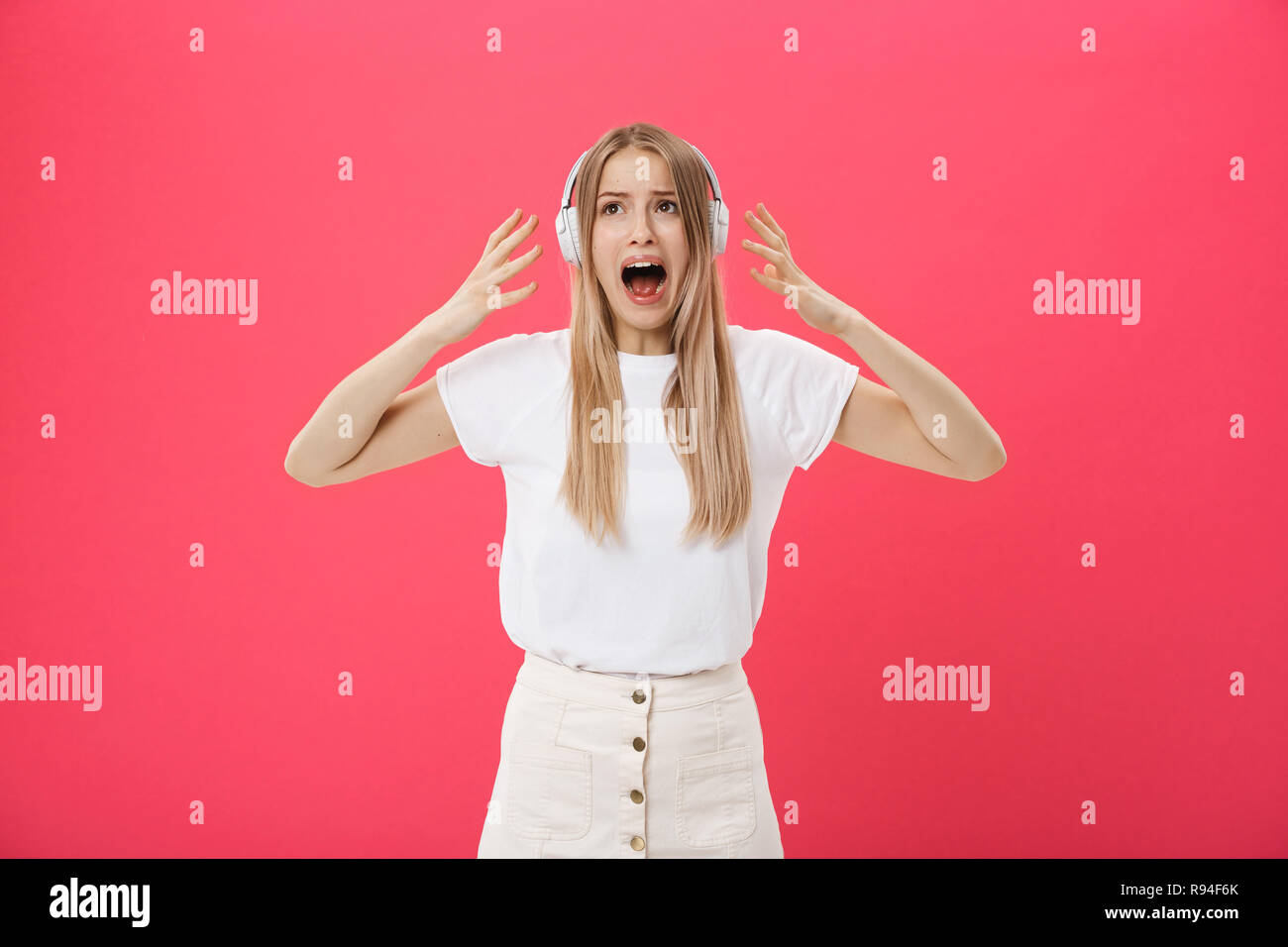 Young woman operator from call center covering ears ignoring annoying ...