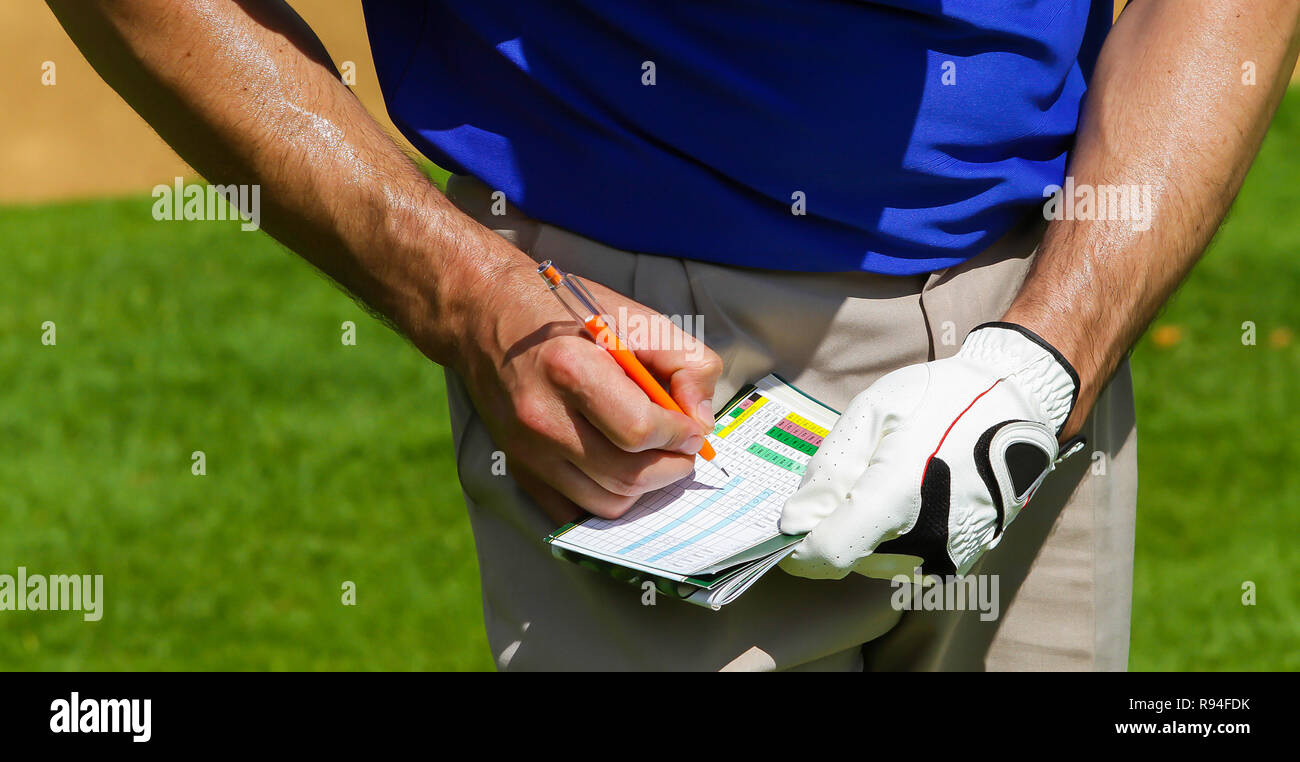 Sweaty Golfer keeping score on scorecard on a sunny day Stock Photo - Alamy