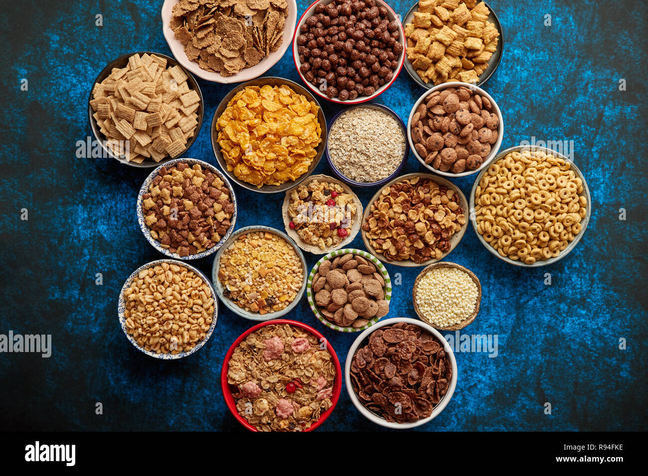 Assortment of different kinds cereals placed in ceramic bowls on table ...