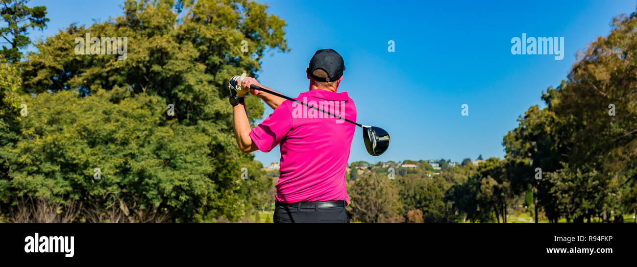 Man teeing off on a golf course Tee with a driver club Stock Photo - Alamy