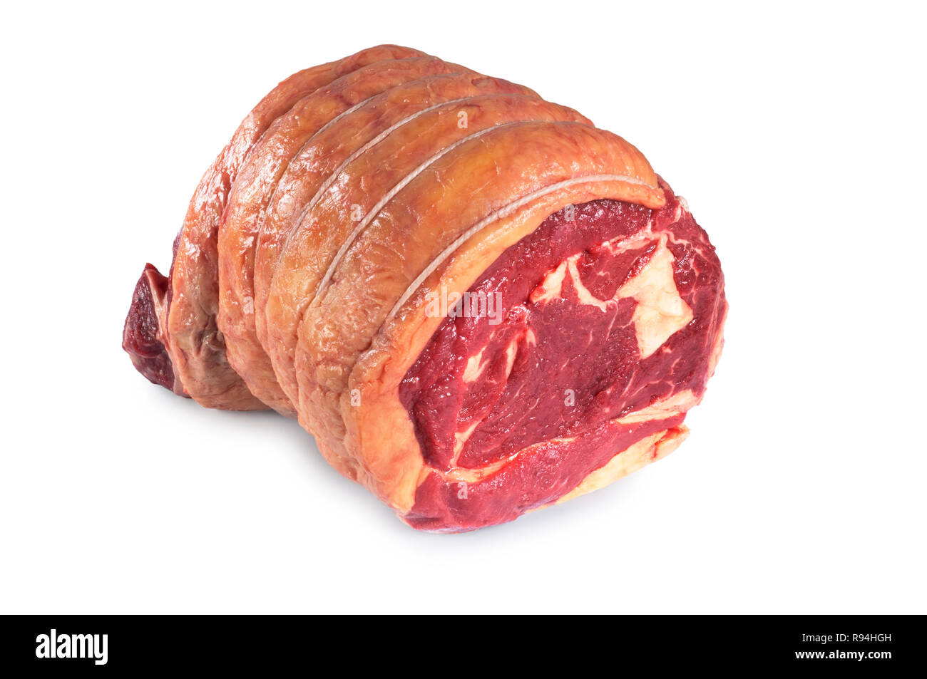 Studio shot of a rolled rib of Dexter beef cut out against a white ...